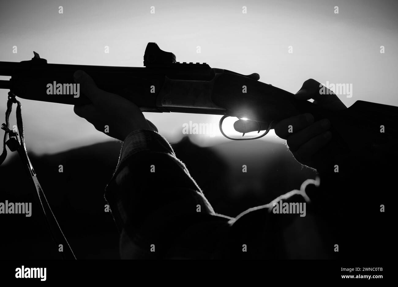 Rifle Hunter Silhouetted in Beautiful Sunset. Hunter with Powerful ...