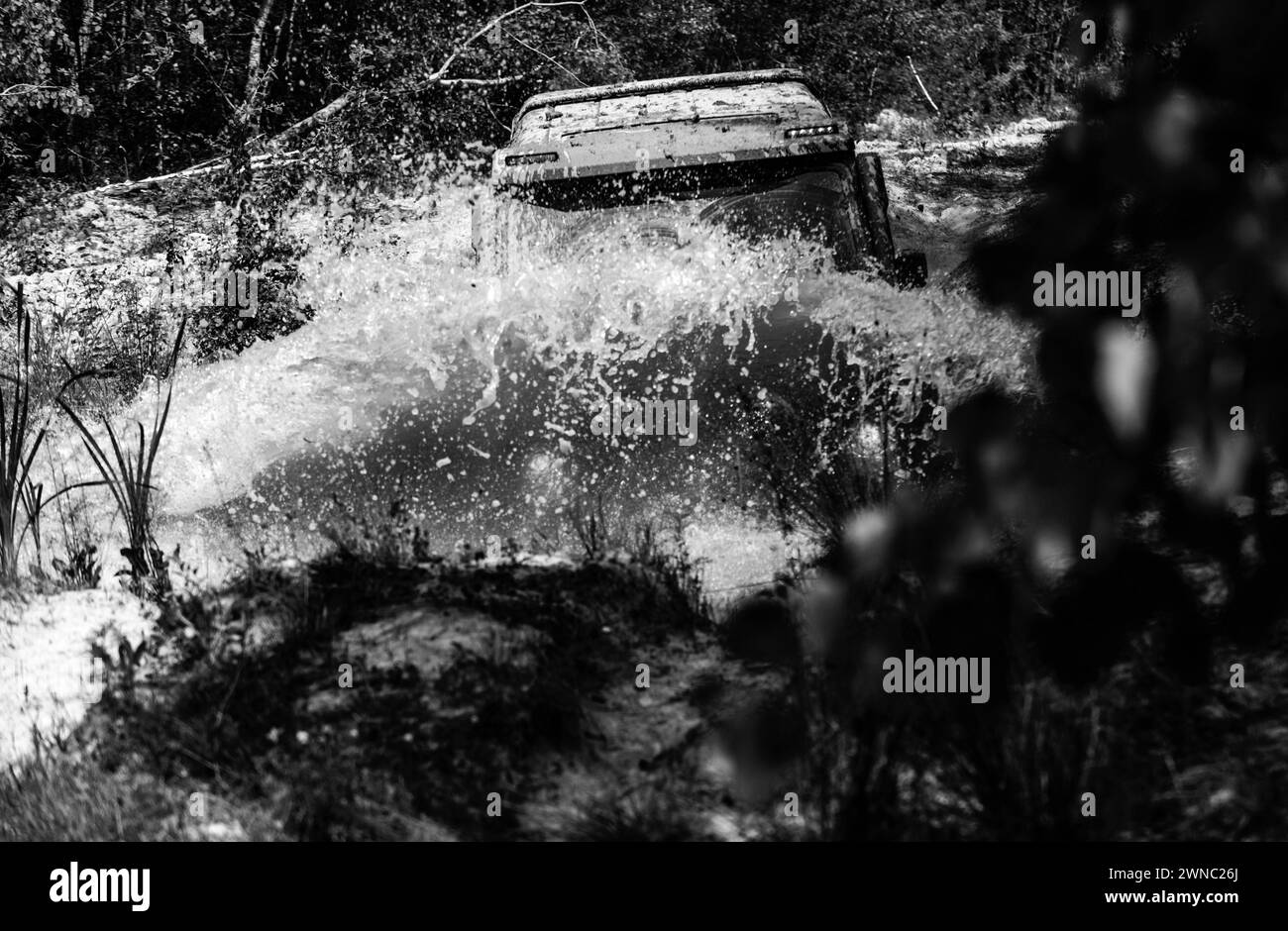 Off-road travel on mountain road. Offroad vehicle coming out of a mud ...