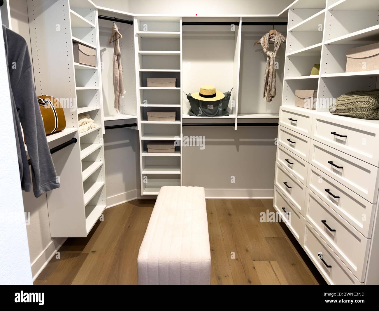 Spacious Walk-In Closet with Custom Shelving and Seating Stock Photo ...