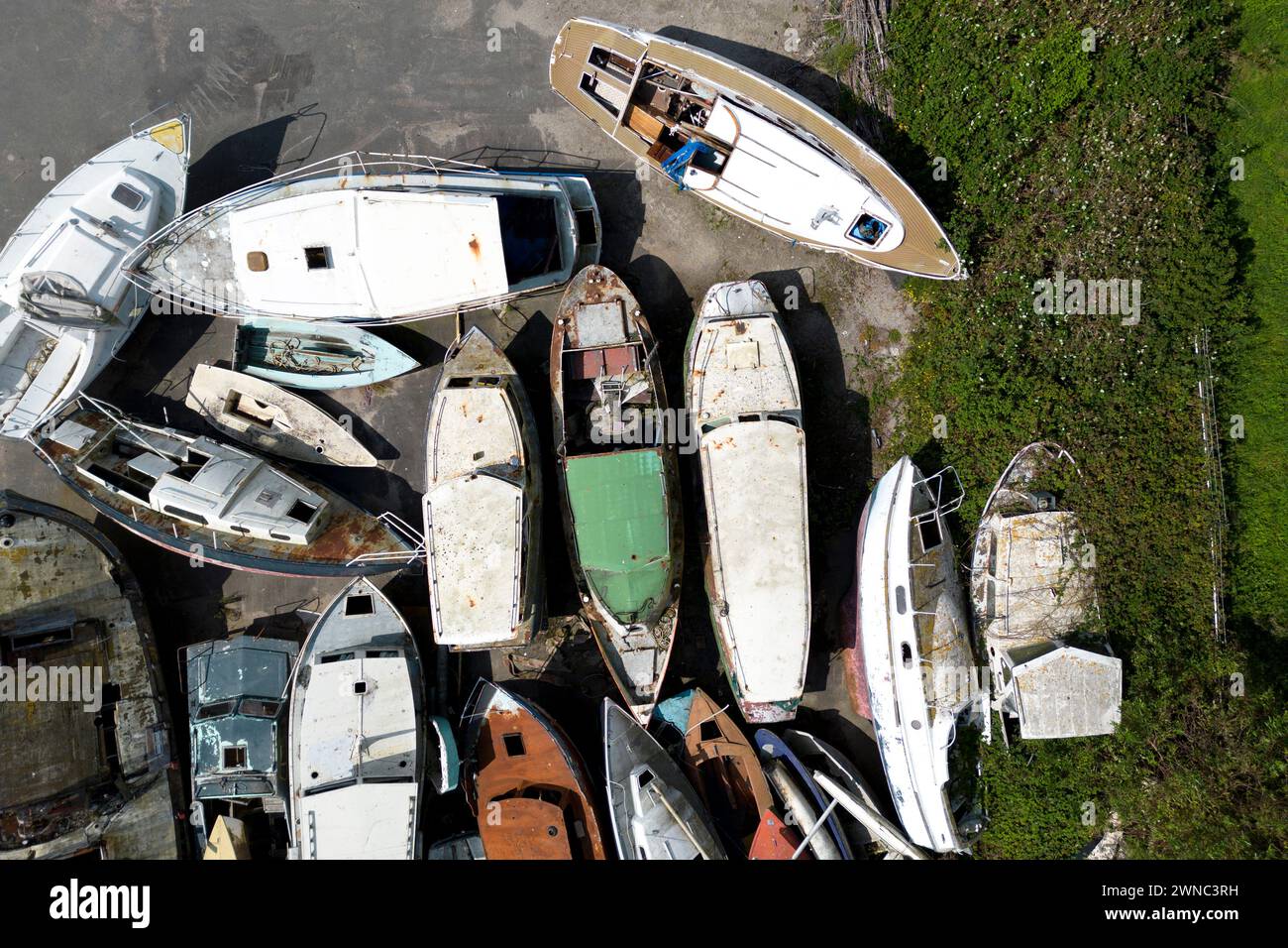 Close-up of corroded and disposed boats dumped at a scrapyard for later ...