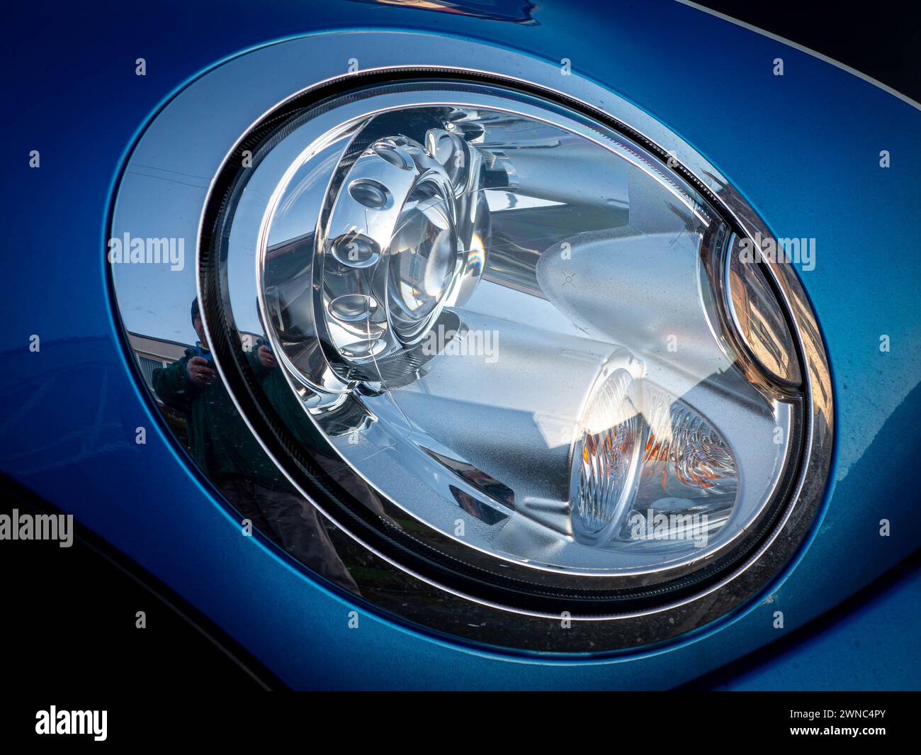 Front headlight cluster on a metallic blue Mini Cooper S Stock Photo ...