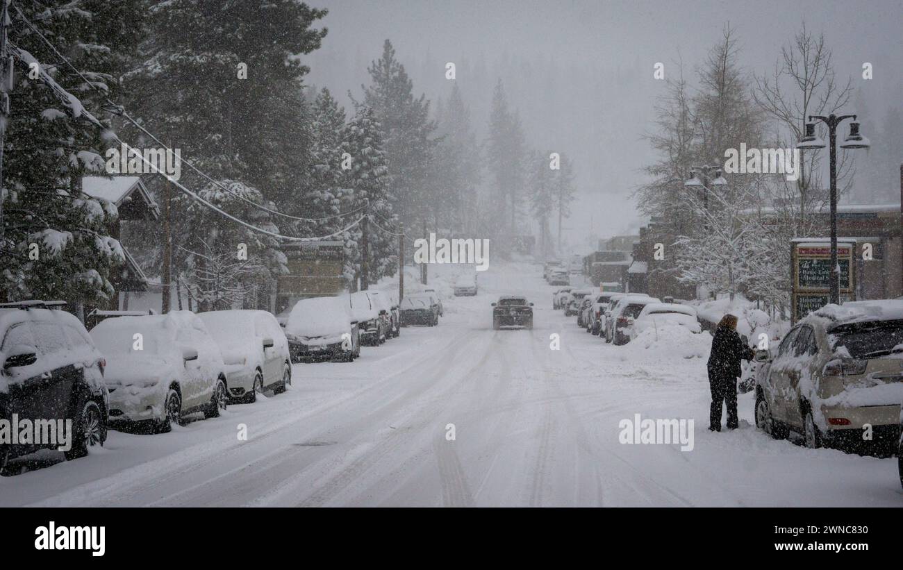 Parked vehicles are covered in snow during a storm Friday, March 1 ...