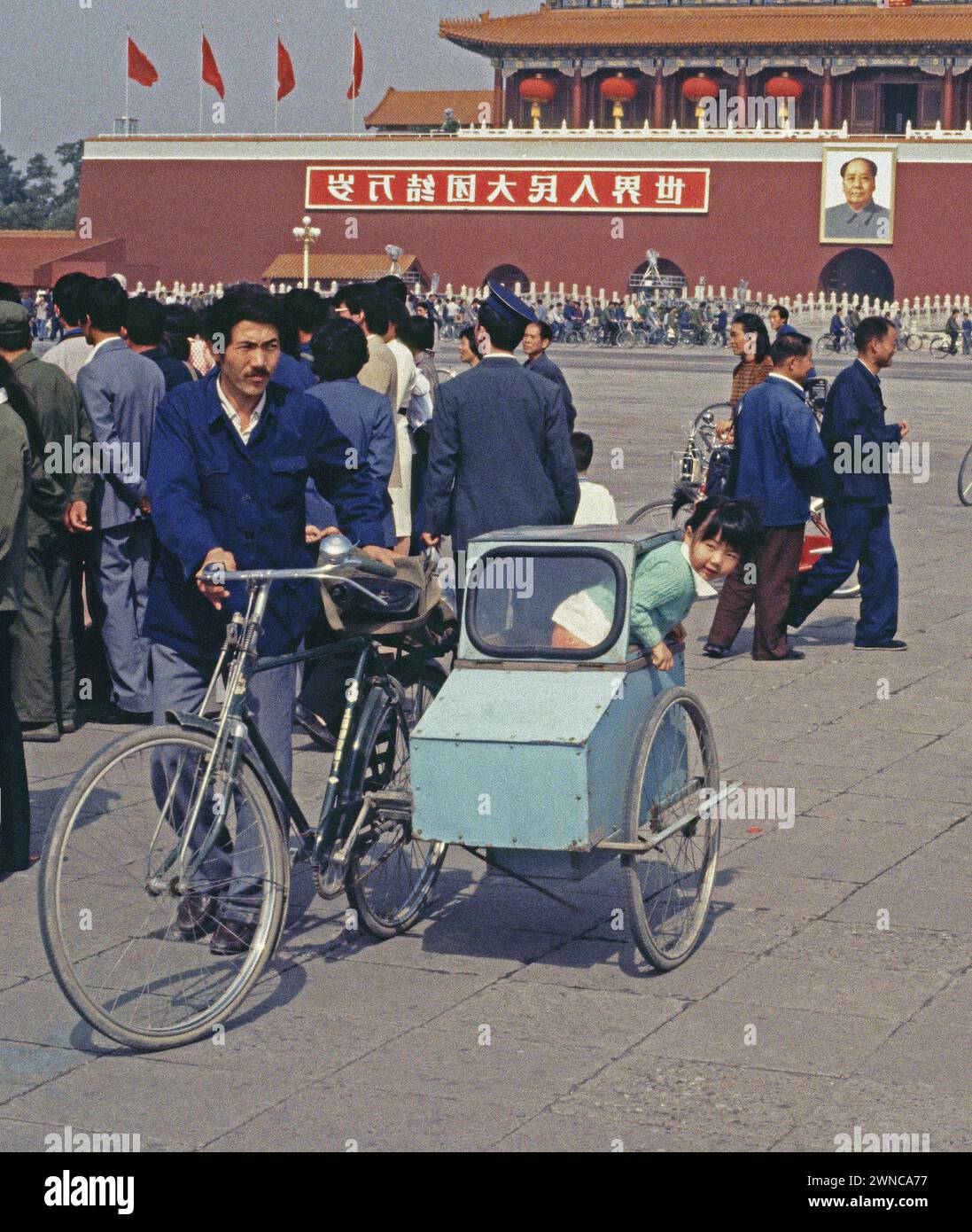father with bicycle and daughter in carriage in Tiananmen Square ...
