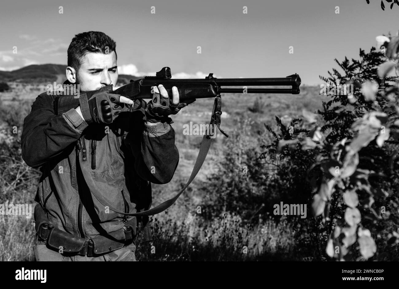 Hunter with Powerful Rifle with Scope Spotting Animals. Hunter with ...