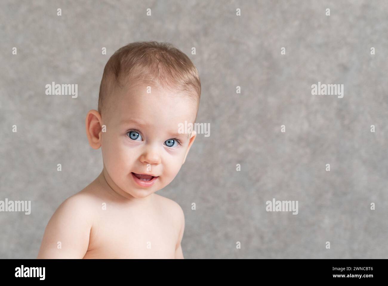 A smiling baby, without a shirt, gazes at the camera Stock Photo - Alamy