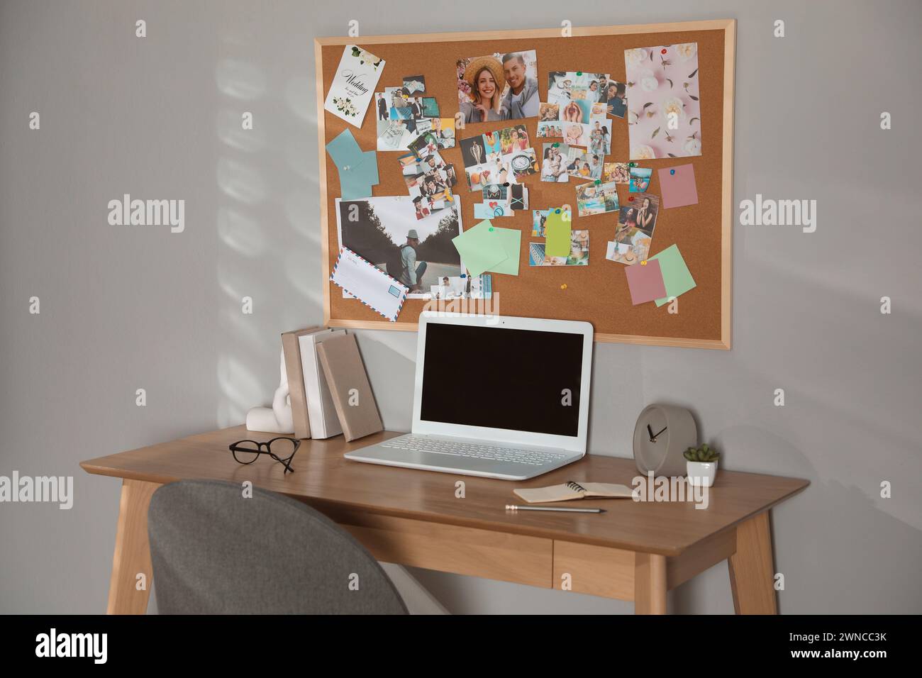 Stylish workplace with vision board and laptop Stock Photo - Alamy