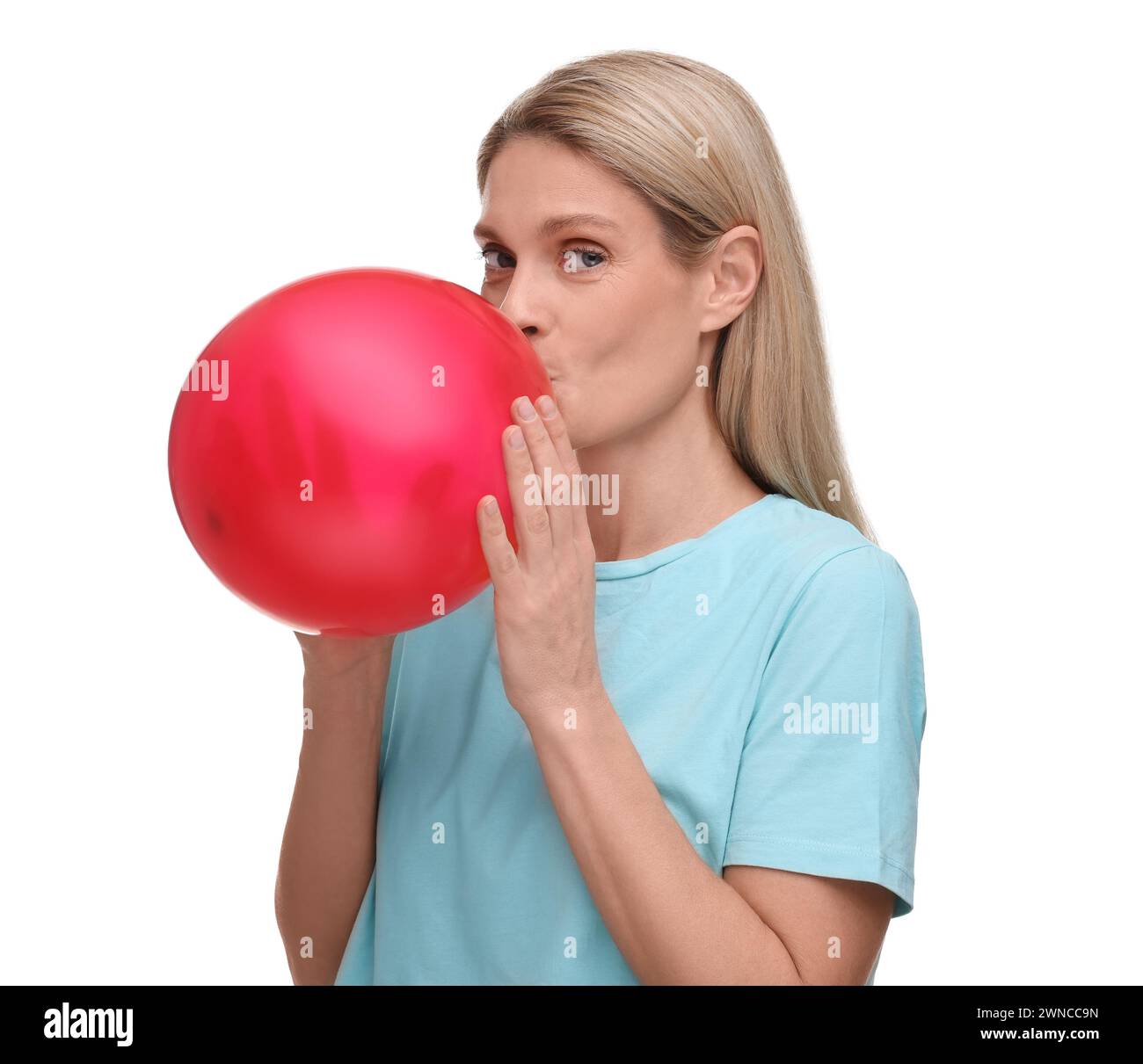 Woman blowing up balloon on white background Stock Photo - Alamy