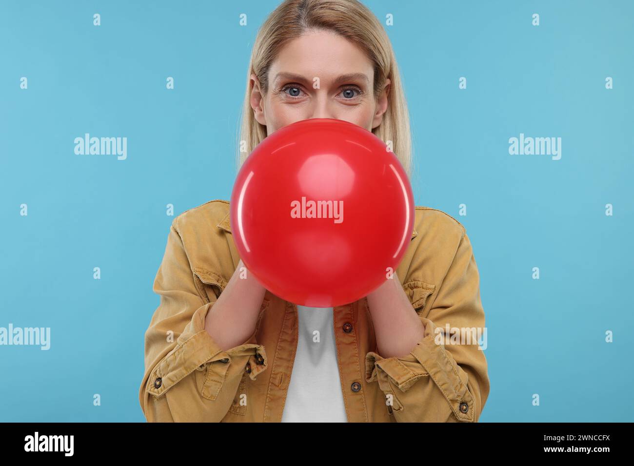 Woman blowing air ballon hi-res stock photography and images - Alamy