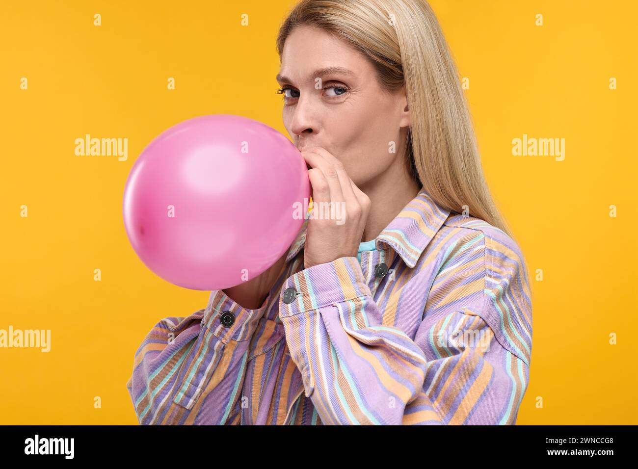Woman blowing air ballon hi-res stock photography and images - Alamy