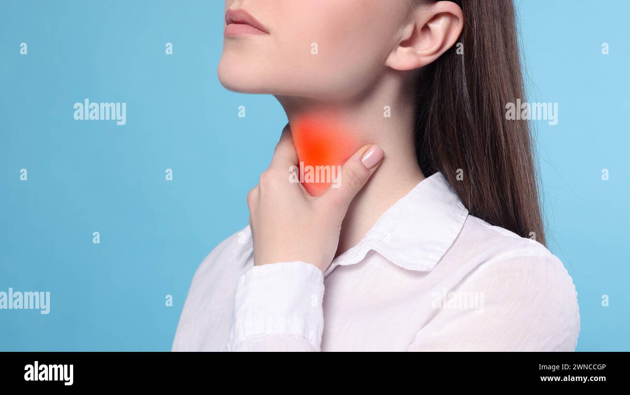 Endocrine system. Woman doing thyroid self examination on light blue ...