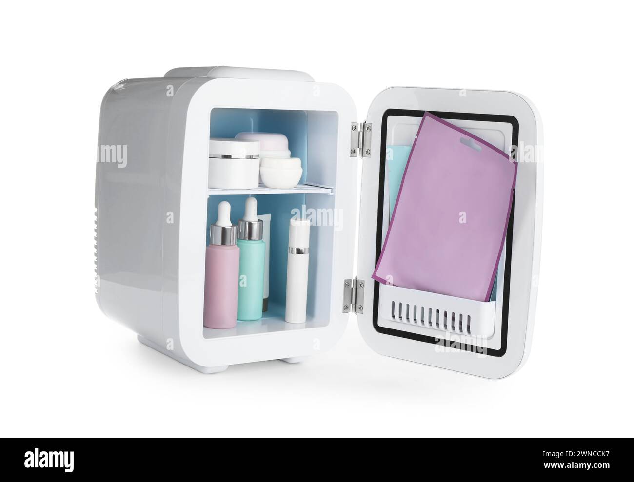 Cosmetics refrigerator with skin care products isolated on white Stock ...