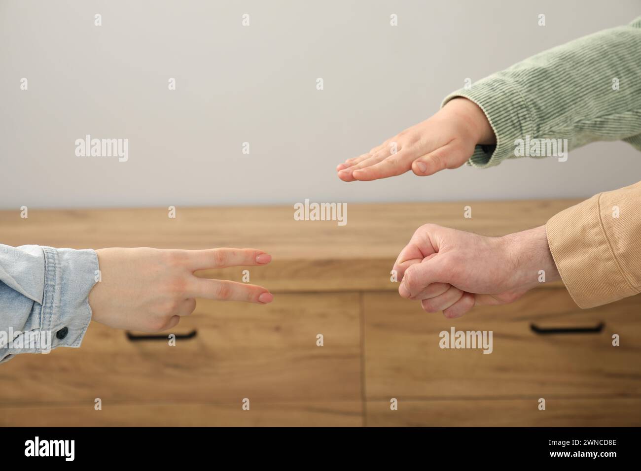 People playing rock, paper and scissors indoors, closeup Stock Photo ...