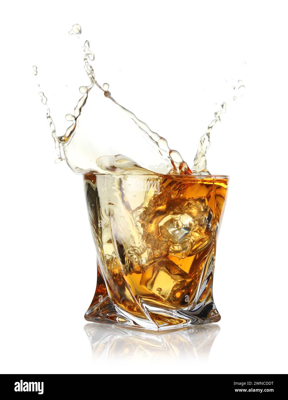 Whiskey splashing out of glass on white background Stock Photo - Alamy