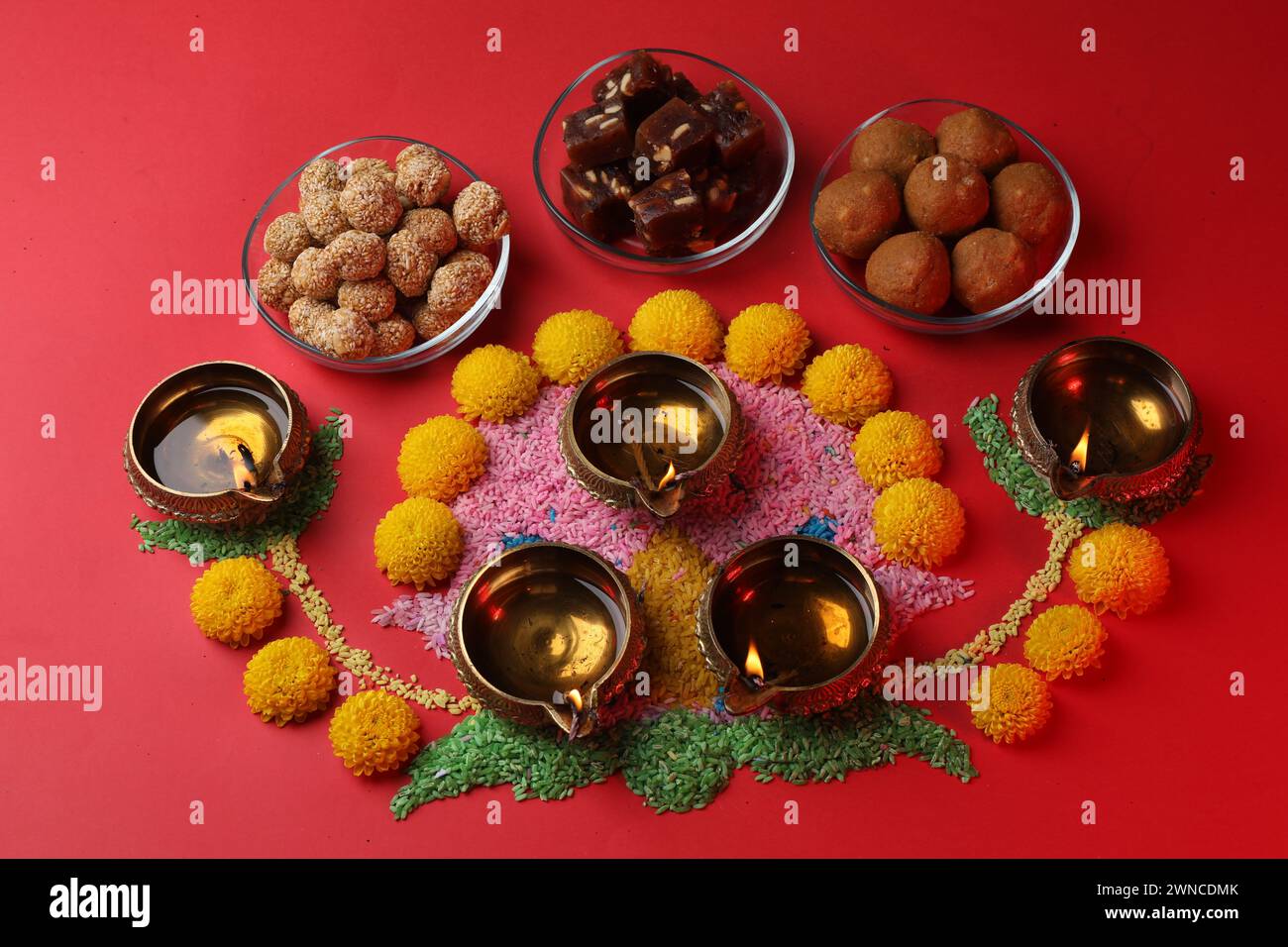 Happy Diwali. Composition with diya lamps, colorful rangoli, flowers ...