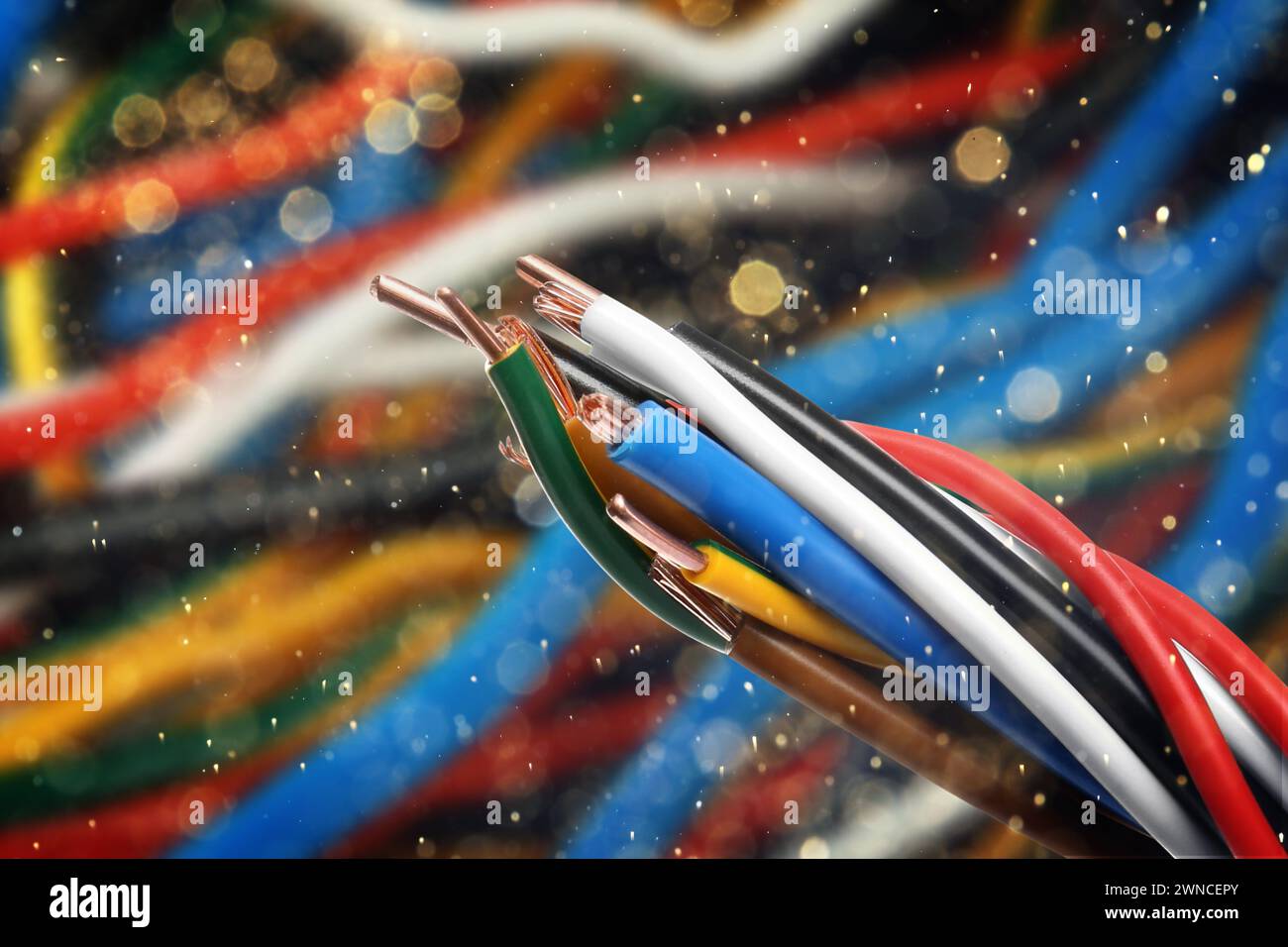 Colorful electrical wires against blurred background, closeup. Bokeh ...