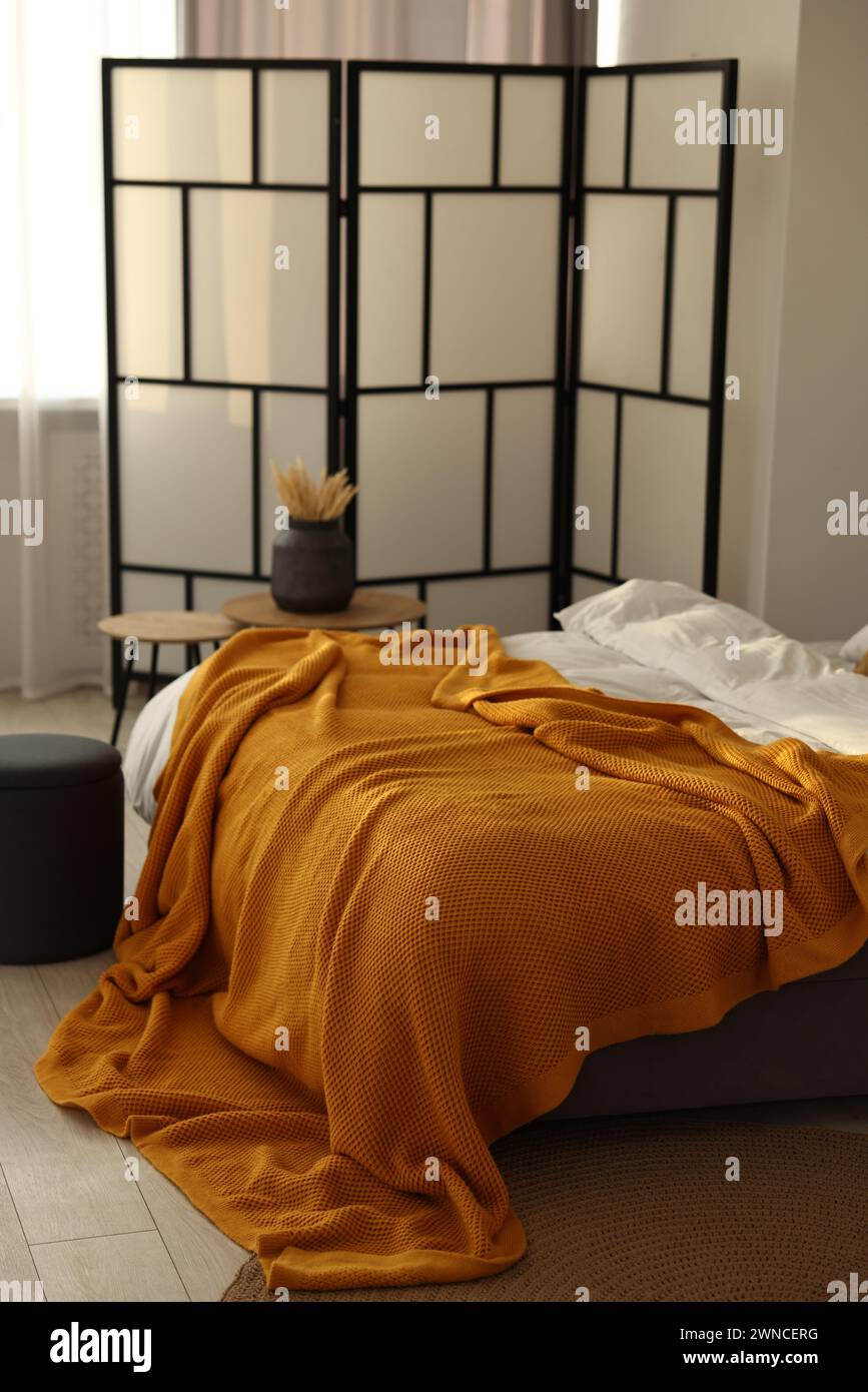 Bright plaid on bed in stylish bedroom. Interior design Stock Photo - Alamy