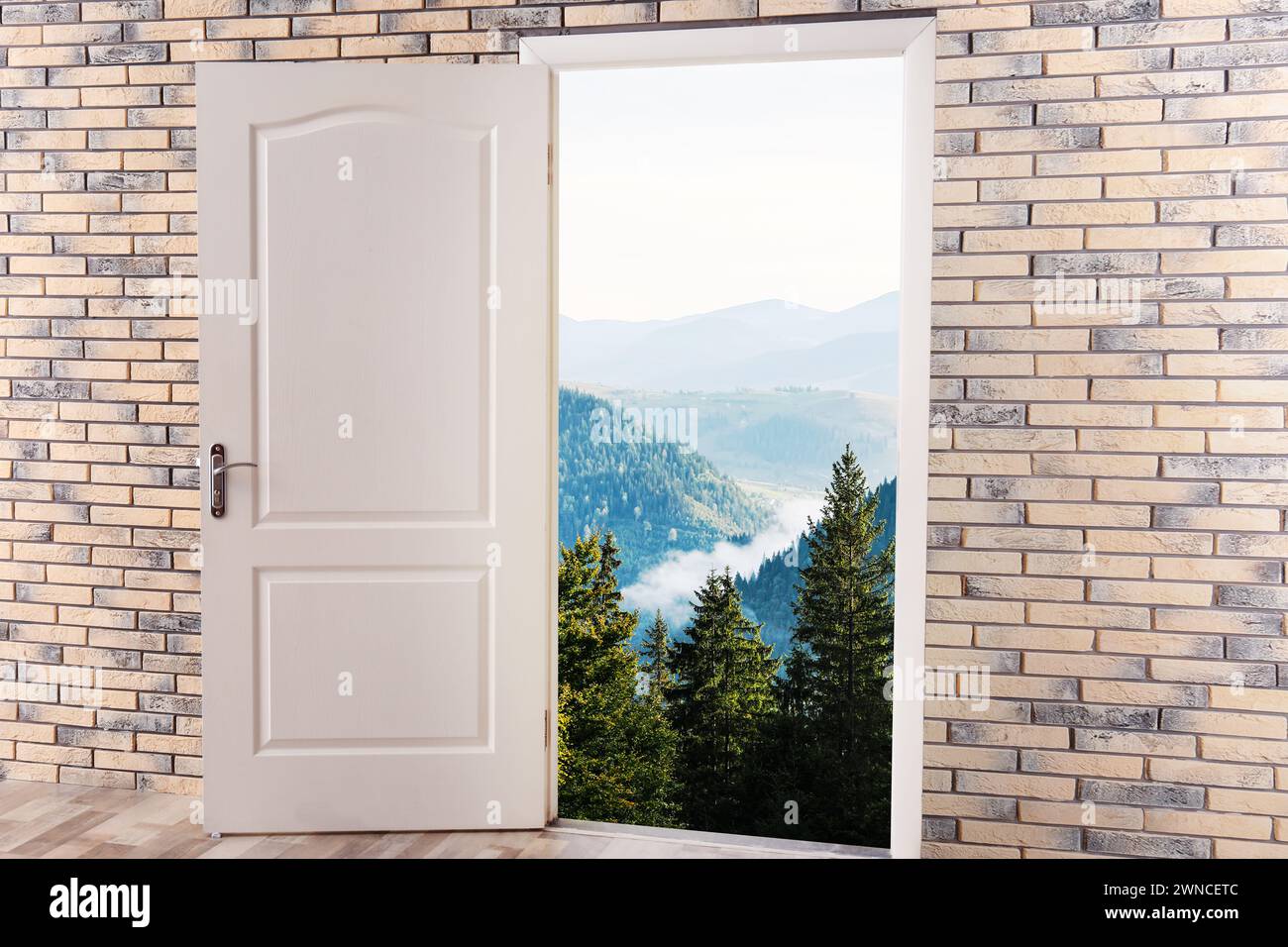 Beautiful mountain landscape visible through open door Stock Photo - Alamy