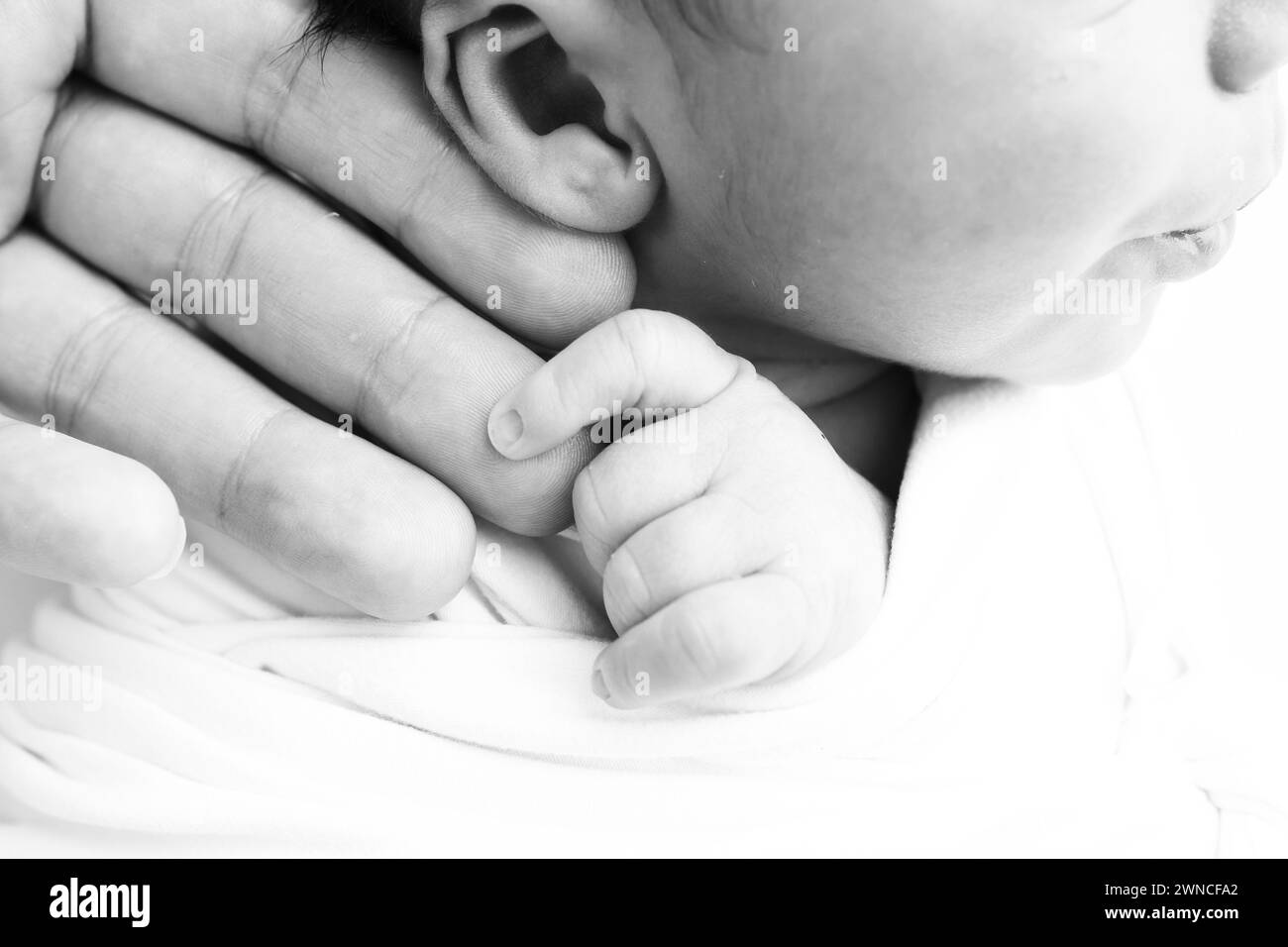 Black and white Photo of Newborn baby after birth tightly holding ...