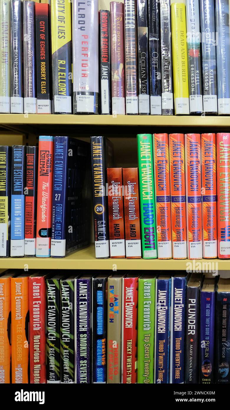Library bookshelf with mystery novels by American writer Janet ...