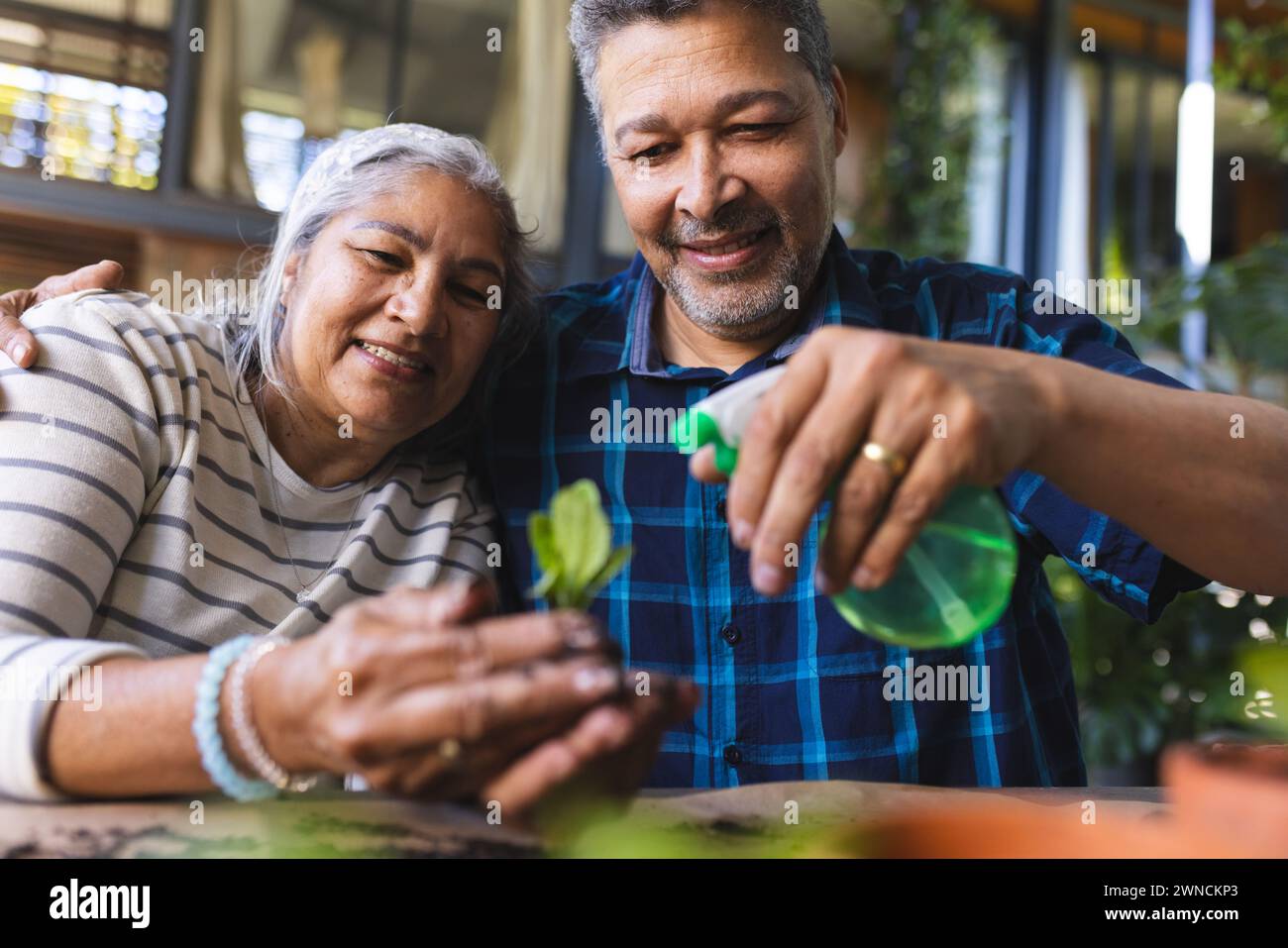 Happy biracial couple gardening together hi-res stock photography and images - Alamy