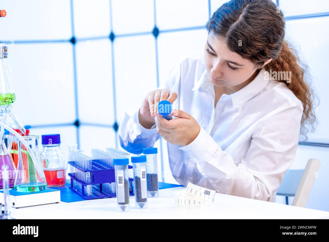 Scientist sticking label on sample Stock Photo - Alamy