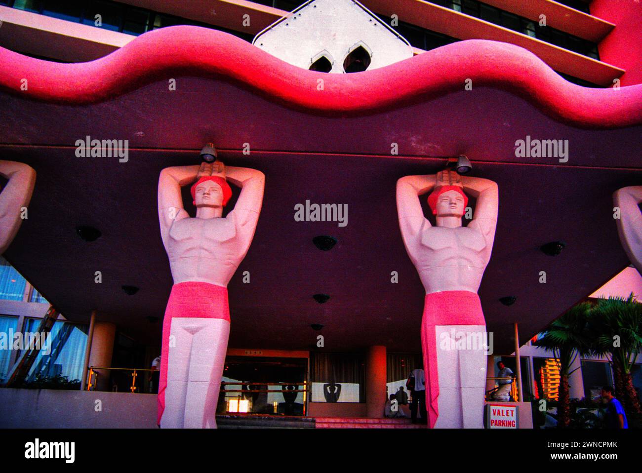 Figures hold up the entrance to an art deco style hotel in Miami Beach ...