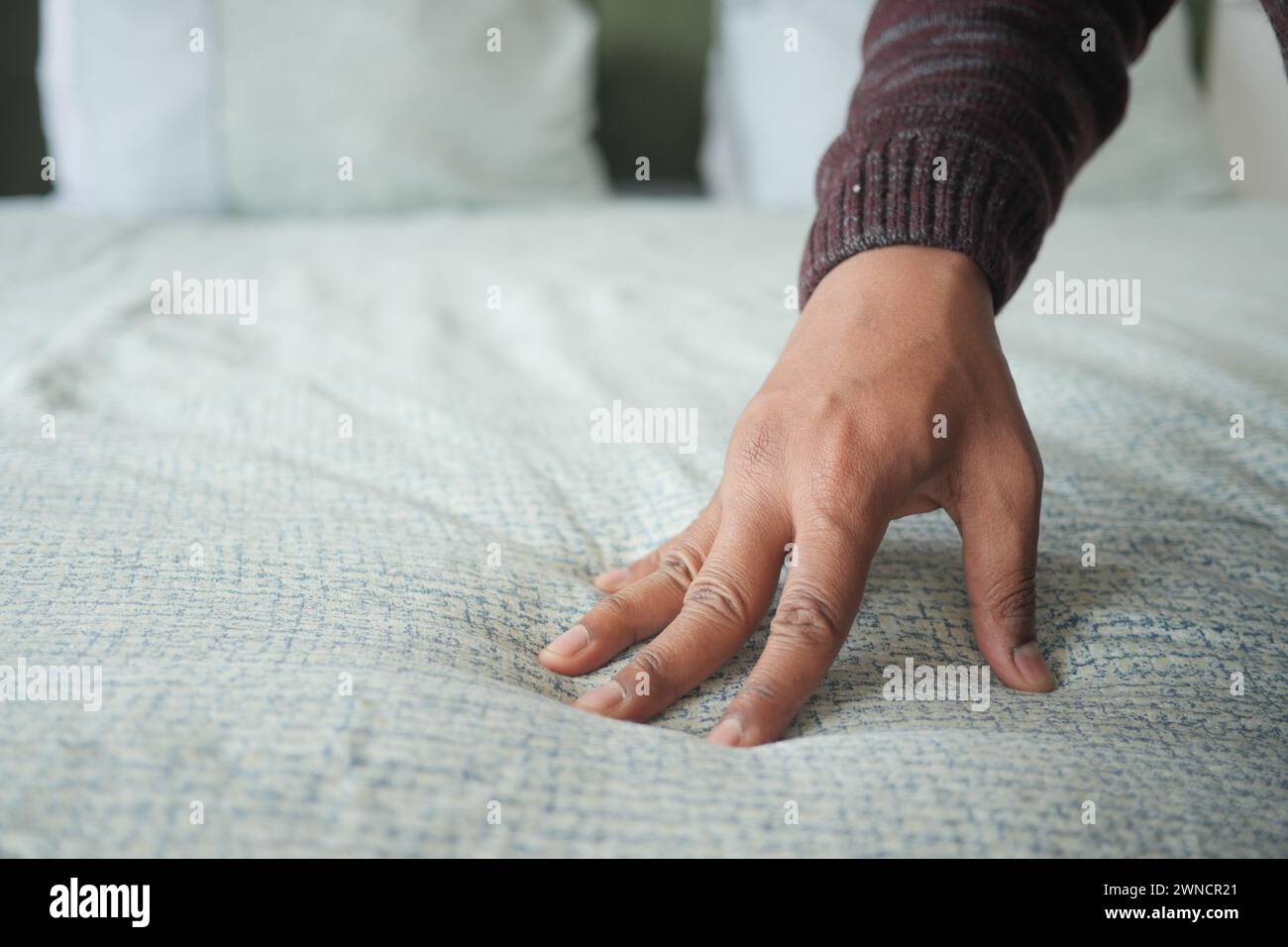 Hand touching and pressing orthopedic mattress on bed Stock Photo - Alamy