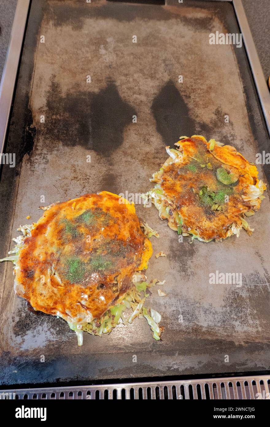 Okonomiyaki Japanese pancake, specialty of Osaka, Japan Stock Photo - Alamy