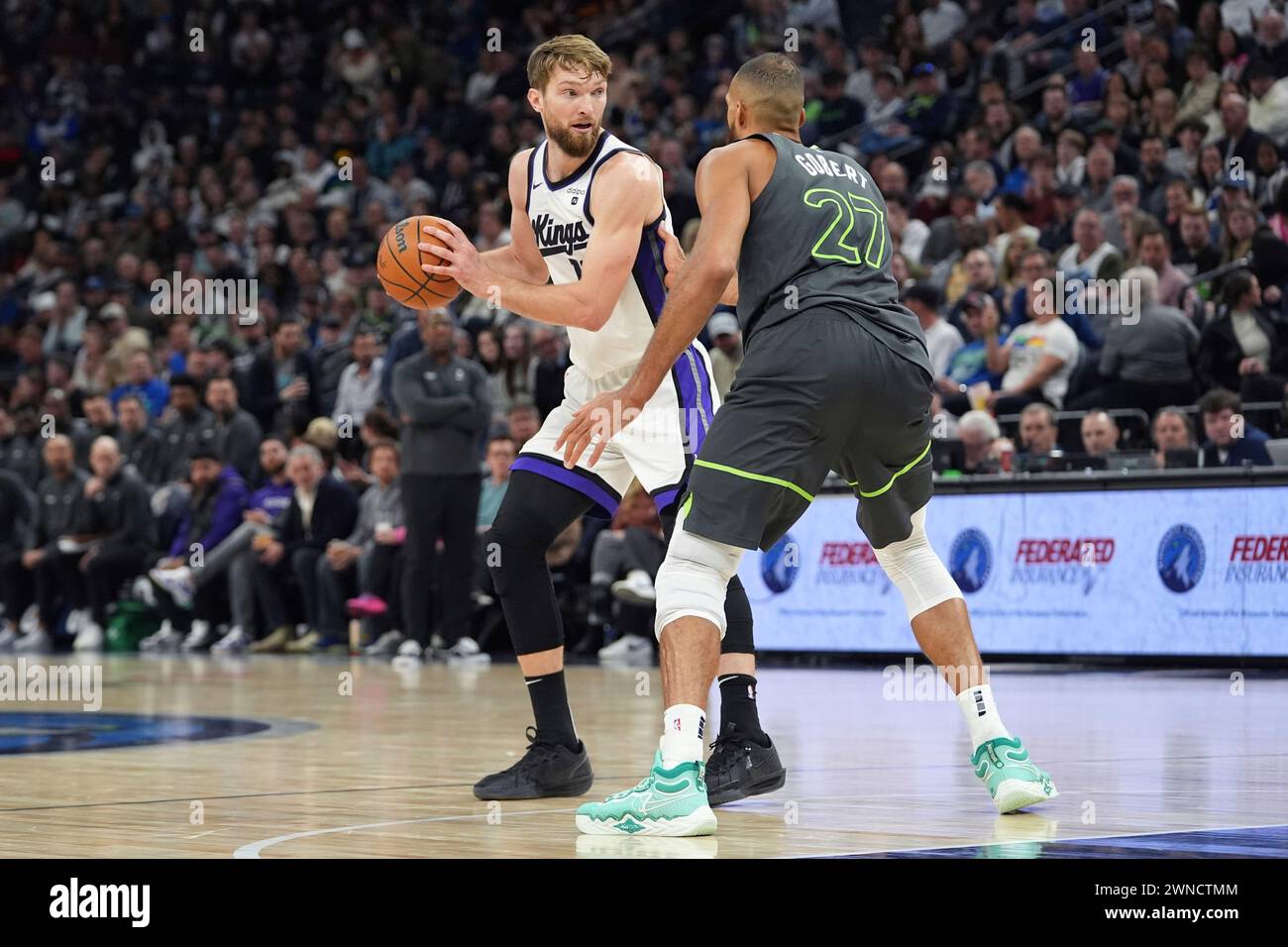 Sacramento Kings forward Domantas Sabonis is defended by Minnesota Timberwolves center Rudy ...
