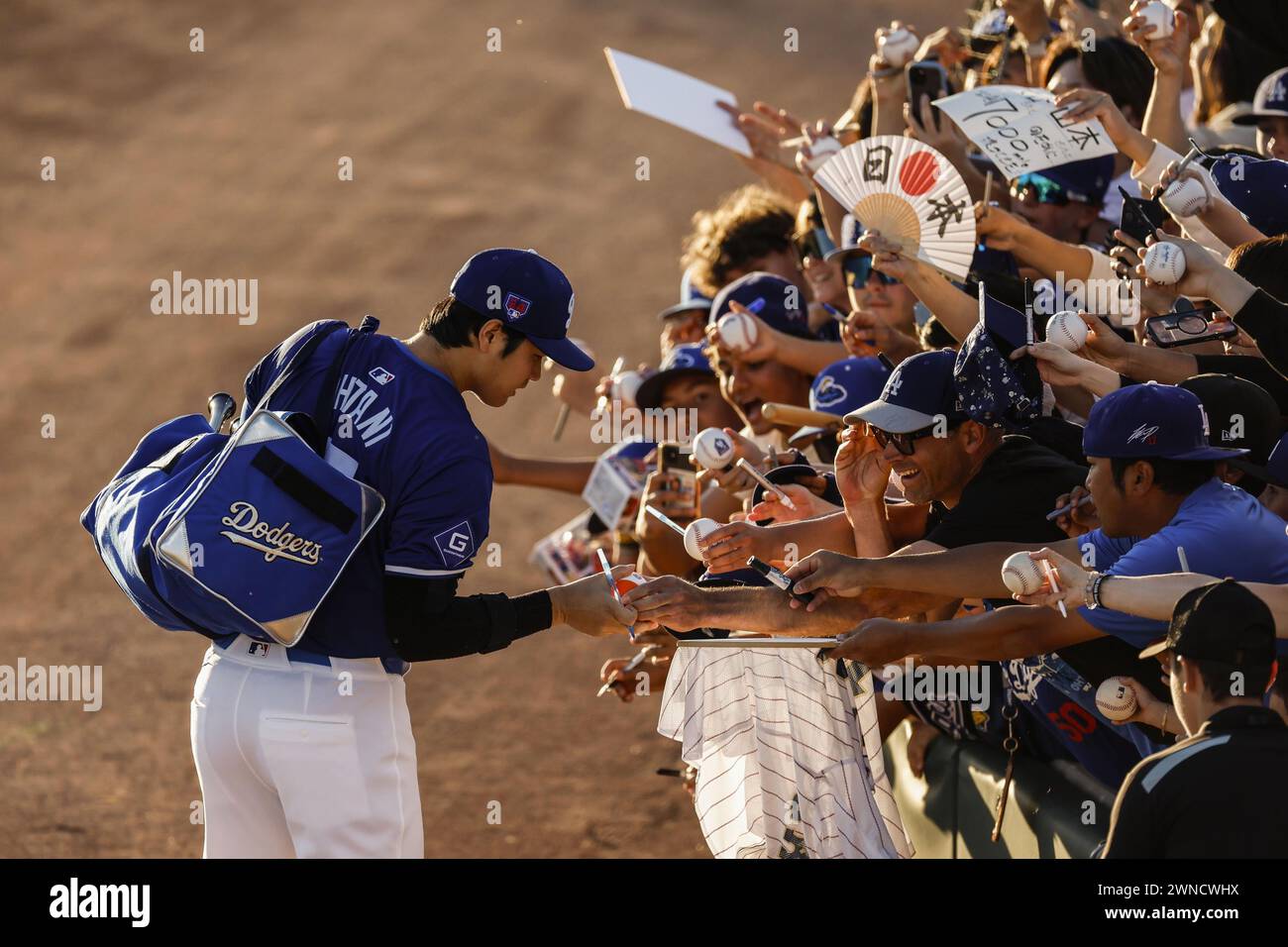 Shohei Ohtani of the Los Angeles Dodgers signs autographs for fans ...