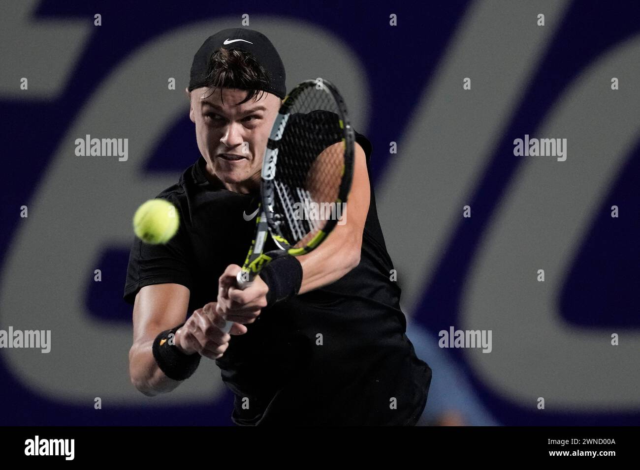 Holger Rune, of Denmark, hits a backhand during a semifinal against ...