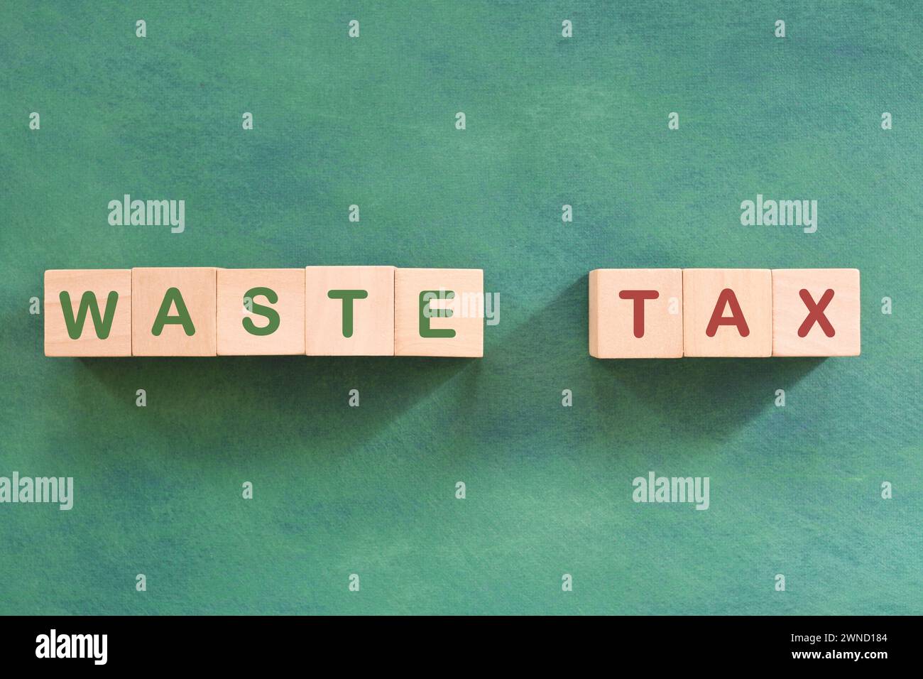 Waste or environmental tax concept. Word in wooden blocks with ...