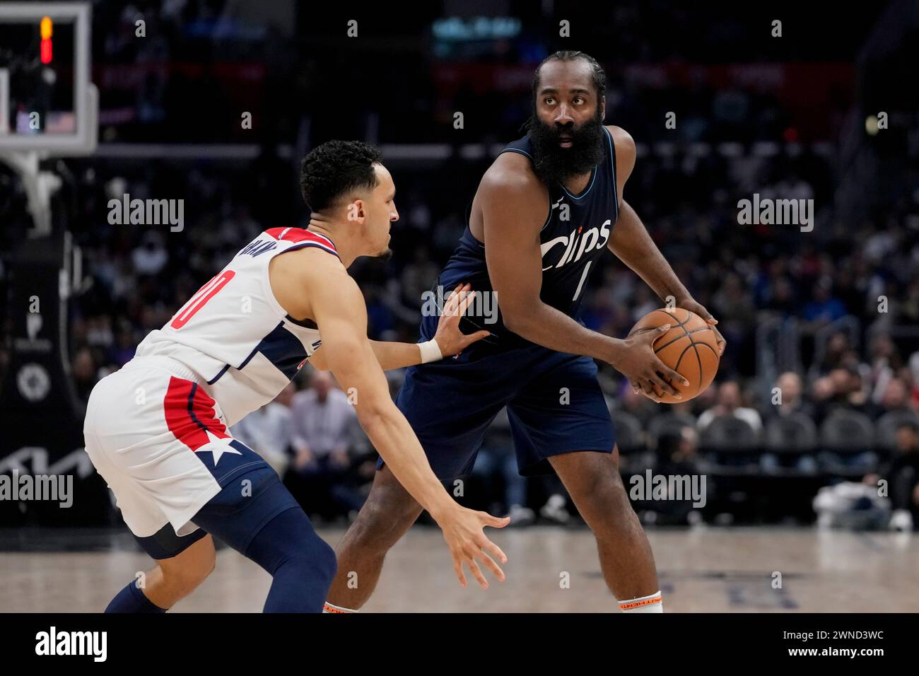 Los Angeles Clippers guard James Harden, right, looks past Washington ...