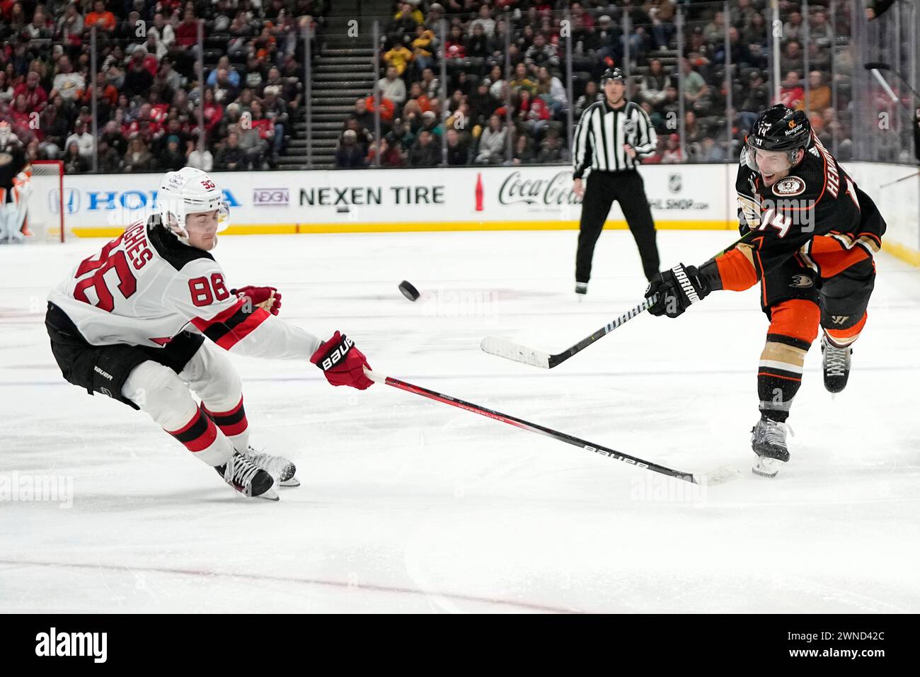 Anaheim Ducks center Adam Henrique, right, shoots the puck as New ...