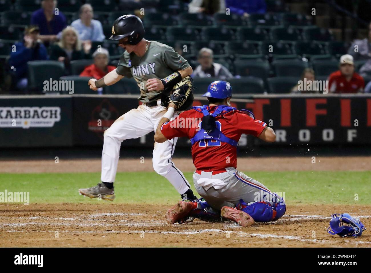 Army runner Chris Barr, left, is tagged out at the plate by Louisiana ...