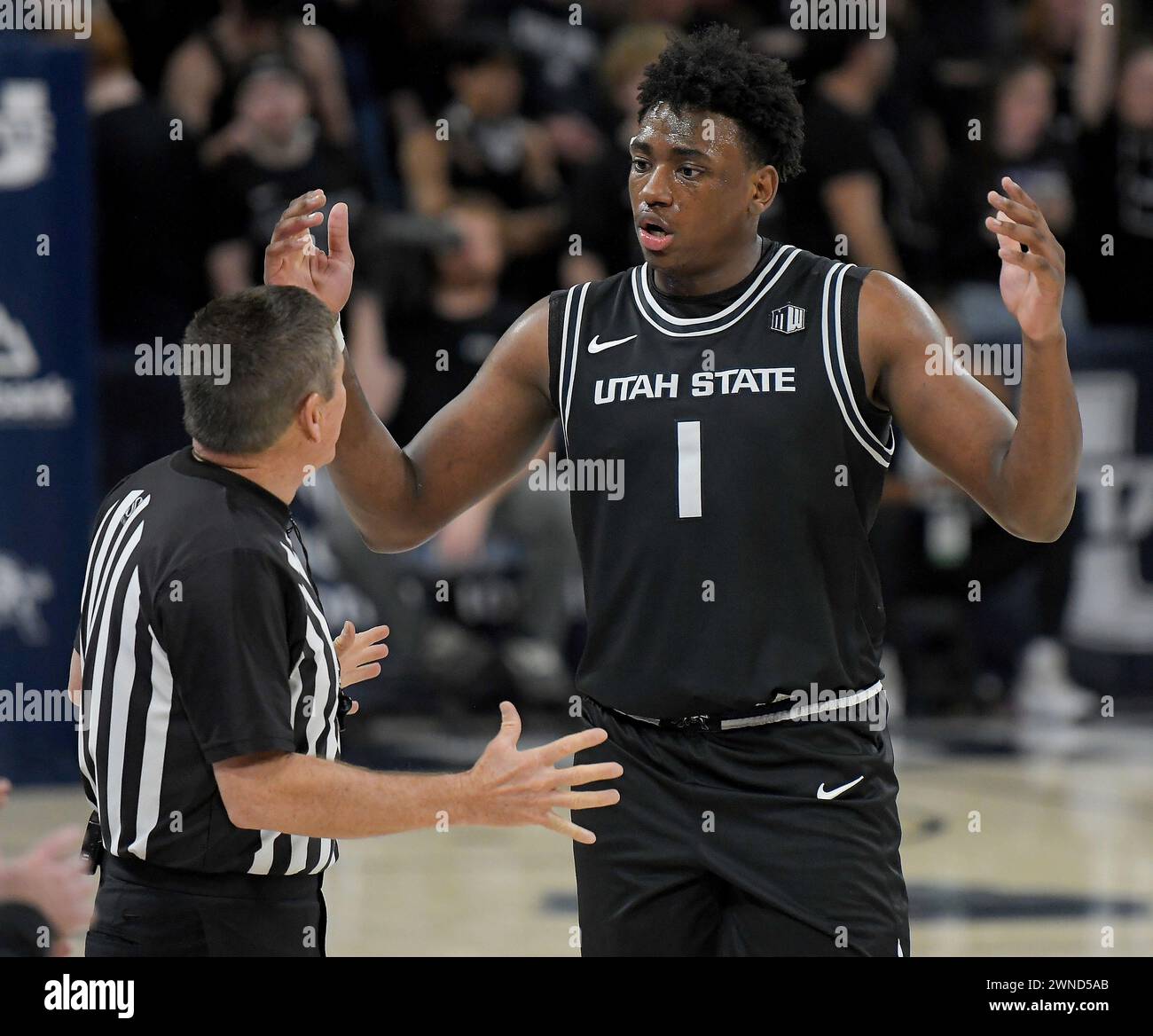 Utah State forward Great Osobor (1) talks to referee Tony Padilla after ...
