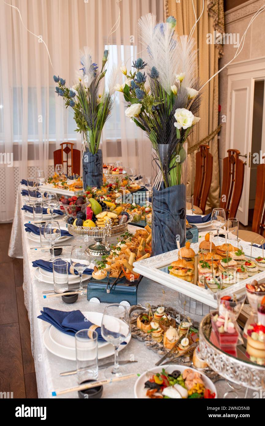 A decadent buffet spread with an array of snacks, sandwiches, fruits ...