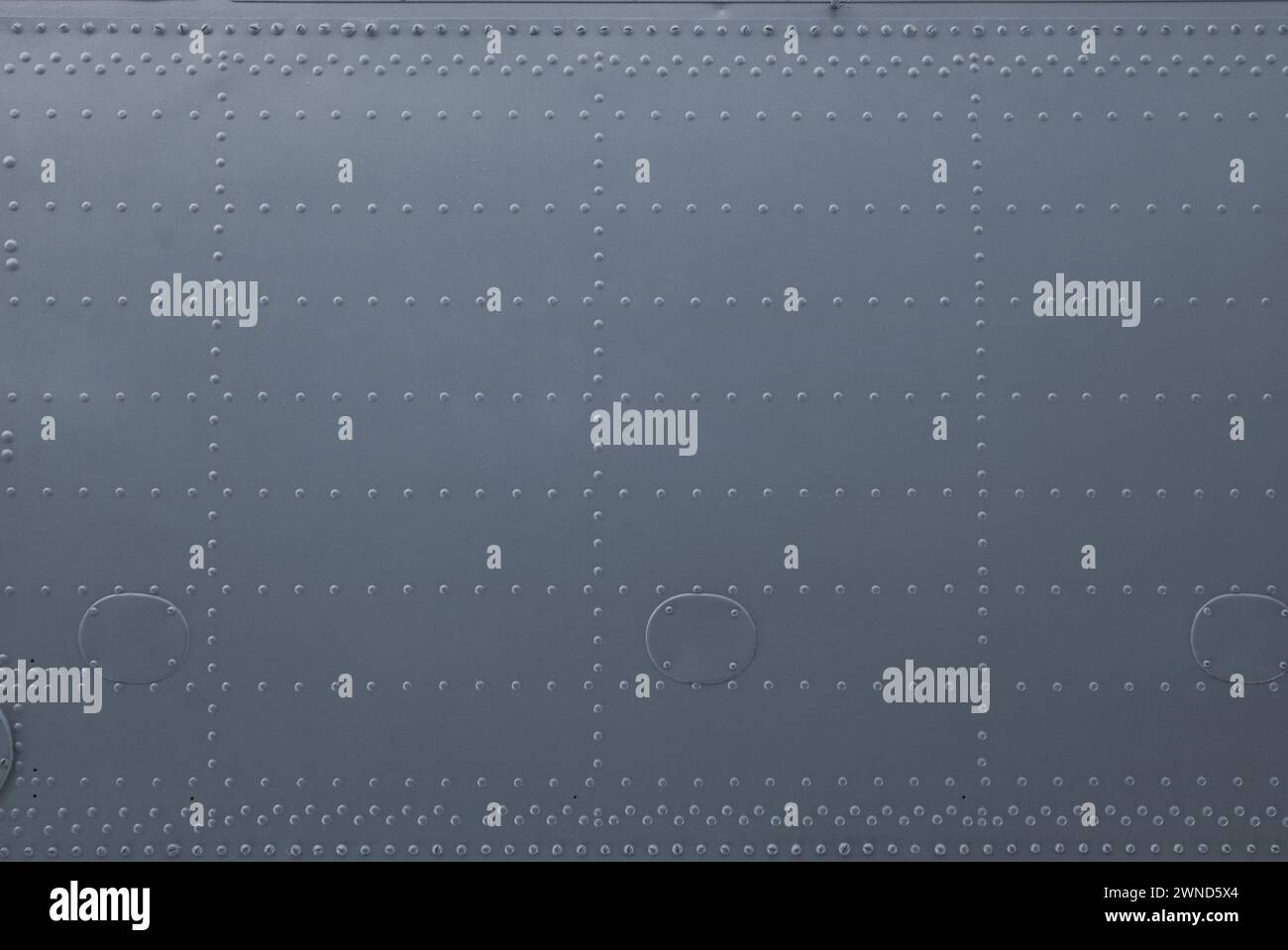 Aircraft skin close up. Rivets on gray metal. Aluminum surface of the ...