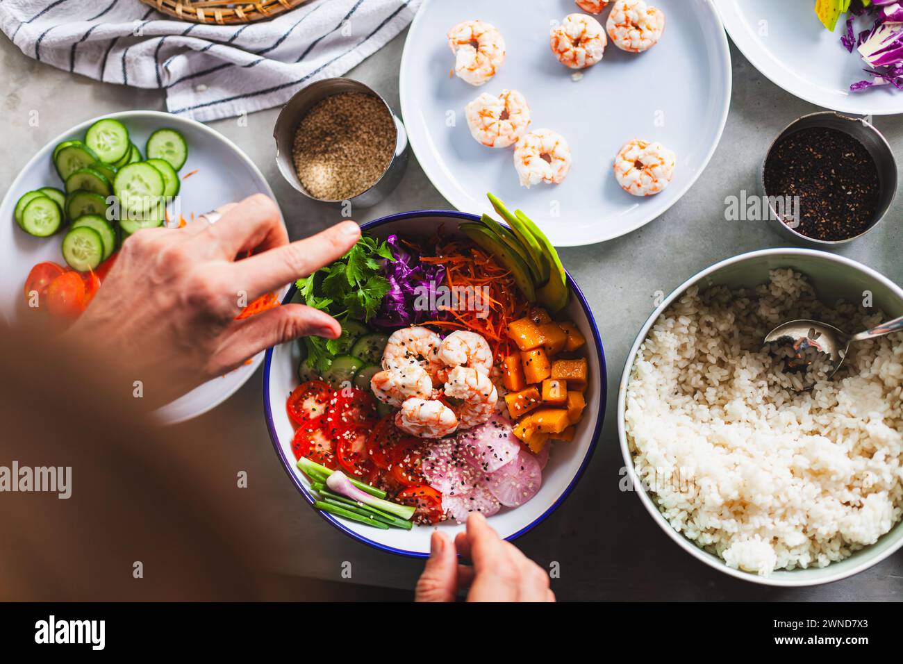 A poke bowl with shrimp prepared by the chef containing white rice ...