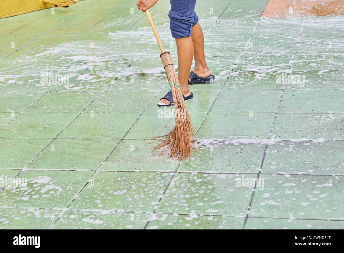 Low section of people cleaning floor Stock Photo - Alamy