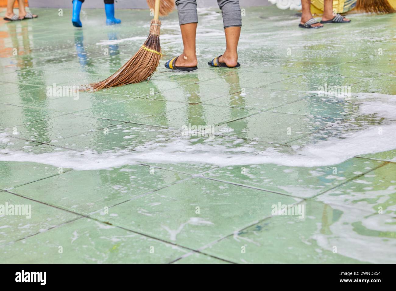Low section of people cleaning floor Stock Photo - Alamy