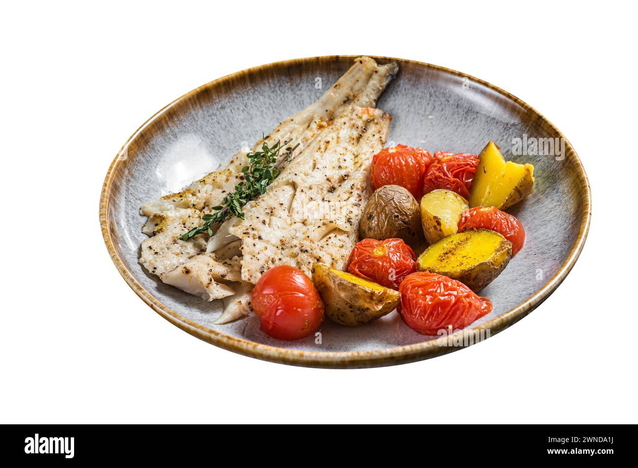 Roasted Pollock fish fillet in plate with garnish tomato and potato ...