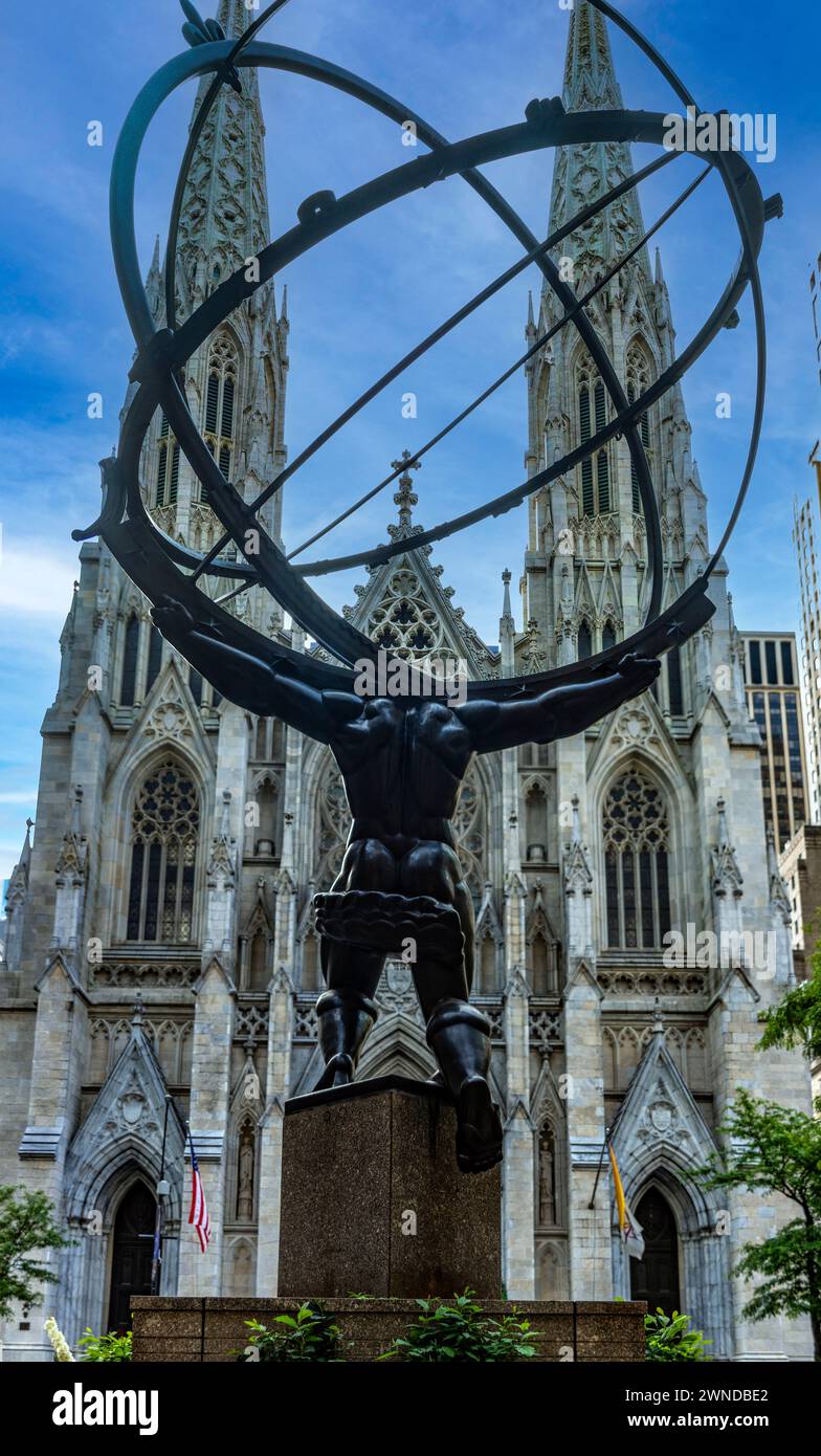 Giant Atlas a bronze statue in front of the decorated neo-Gothic style ...