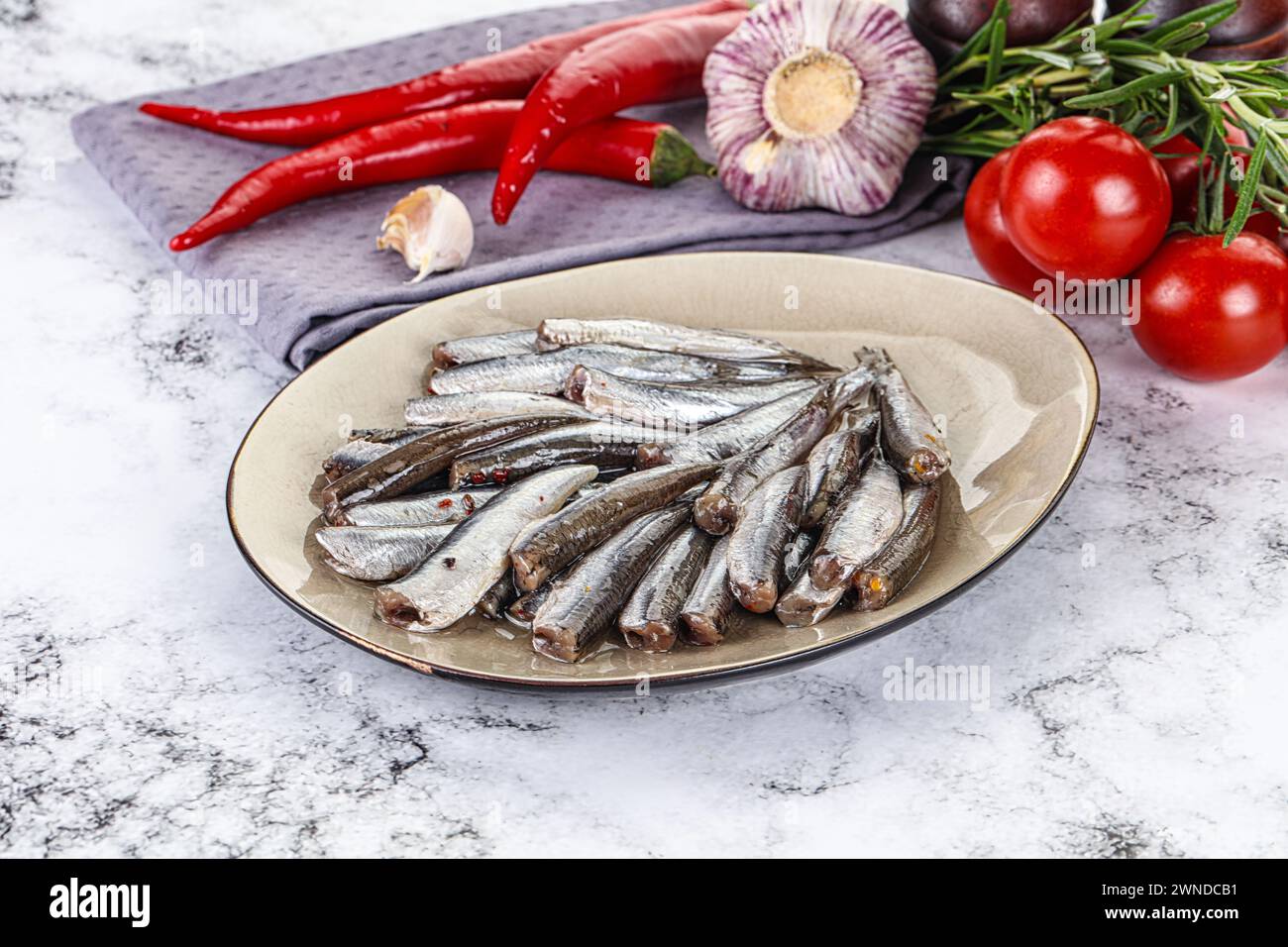 Pickled anchovy fish in the plate Stock Photo - Alamy