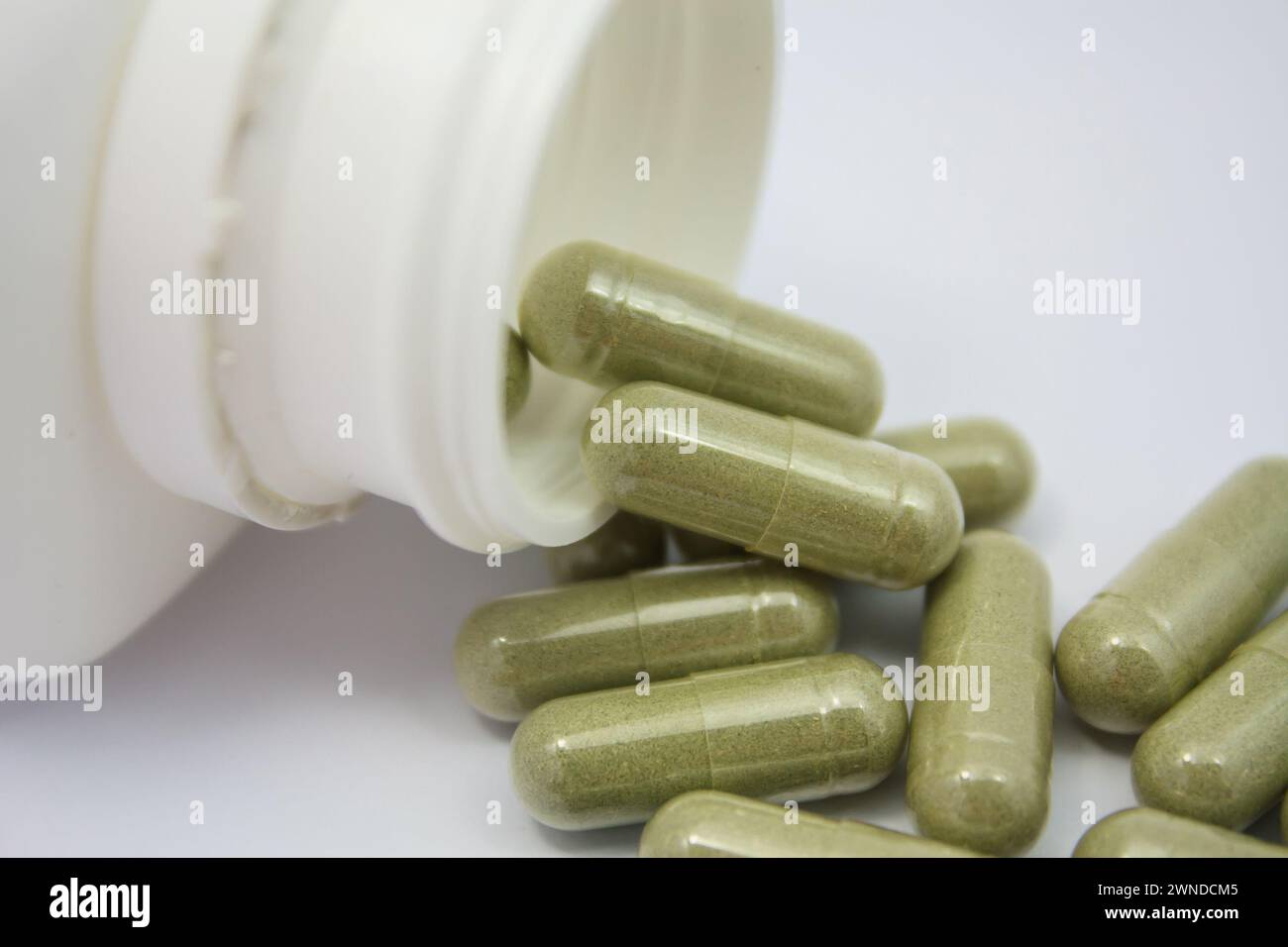 herbal capsules spilling out of a bottle Stock Photo - Alamy