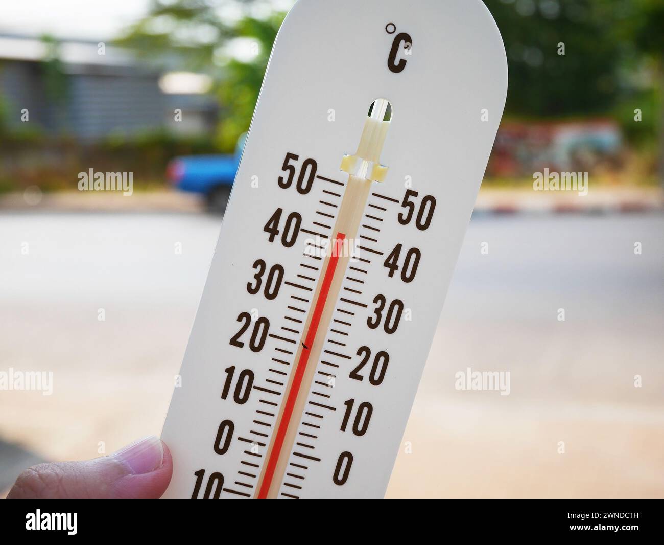 hand hold thermometer showing temperature in degrees Celsius, Hot ...