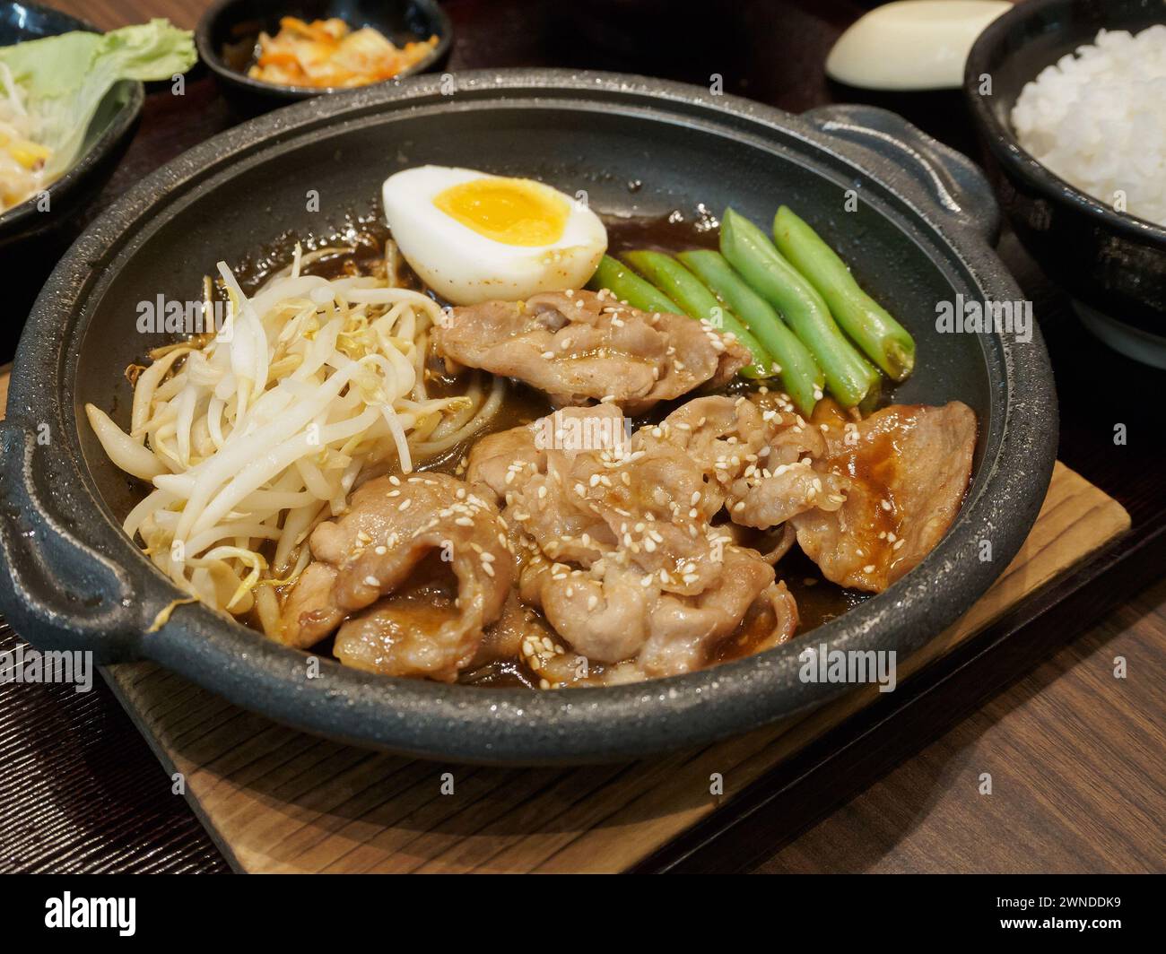 pork teppanyaki with egg and vegetables in hot plate Japanese Cooking ...