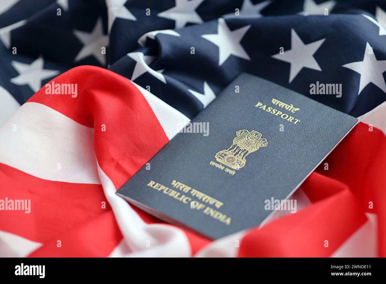Blue Indian passport on United States national flag background close up ...