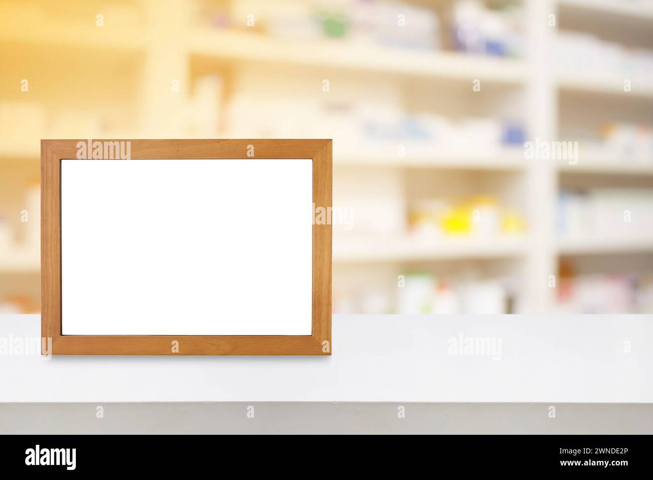 wood photo frame on the pharmacy counter over blur shelves of drug in ...
