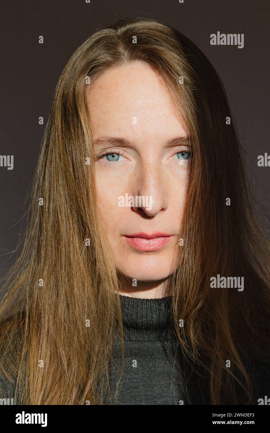 Vertical composition. Portrait of an adult young woman with long blond ...